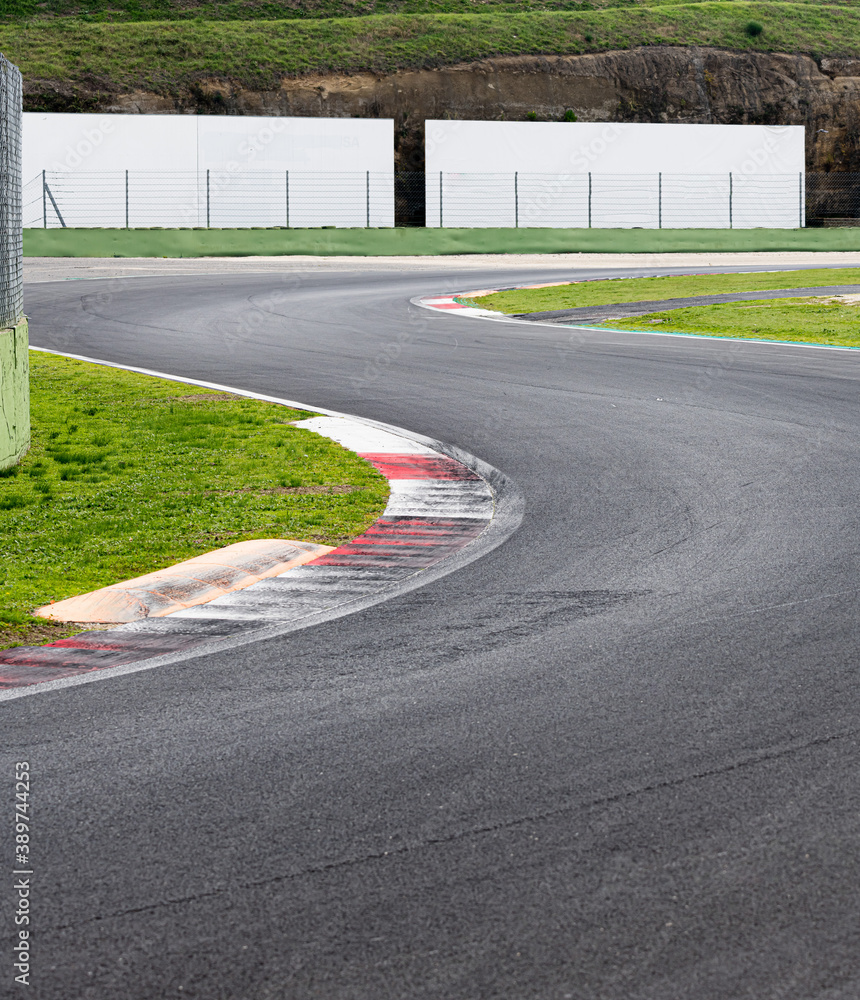 Double turn chicane asphalt track motor sport circuit with white banner ...