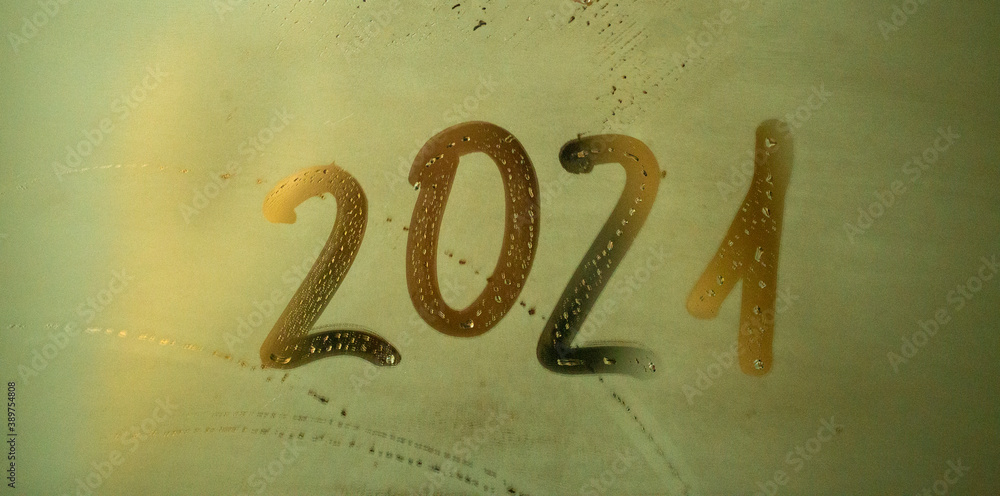 new year's numbers 2021 written on a fogged bathroom window in partial ...
