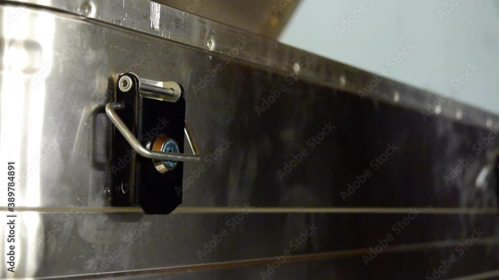 A hand opens the closure of a metal box and opens it Stock ビデオ | Adobe ...