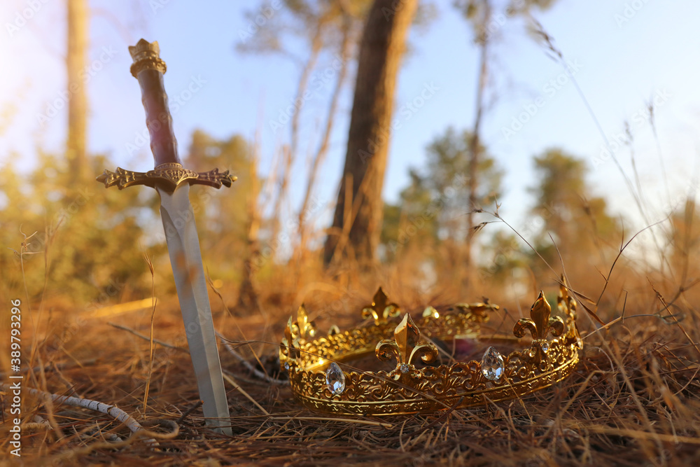 mysterious and magical photo of gold king crown and sword in the ...