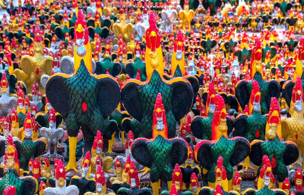 Chicken statues of various colors and sizes that people worship in the ...