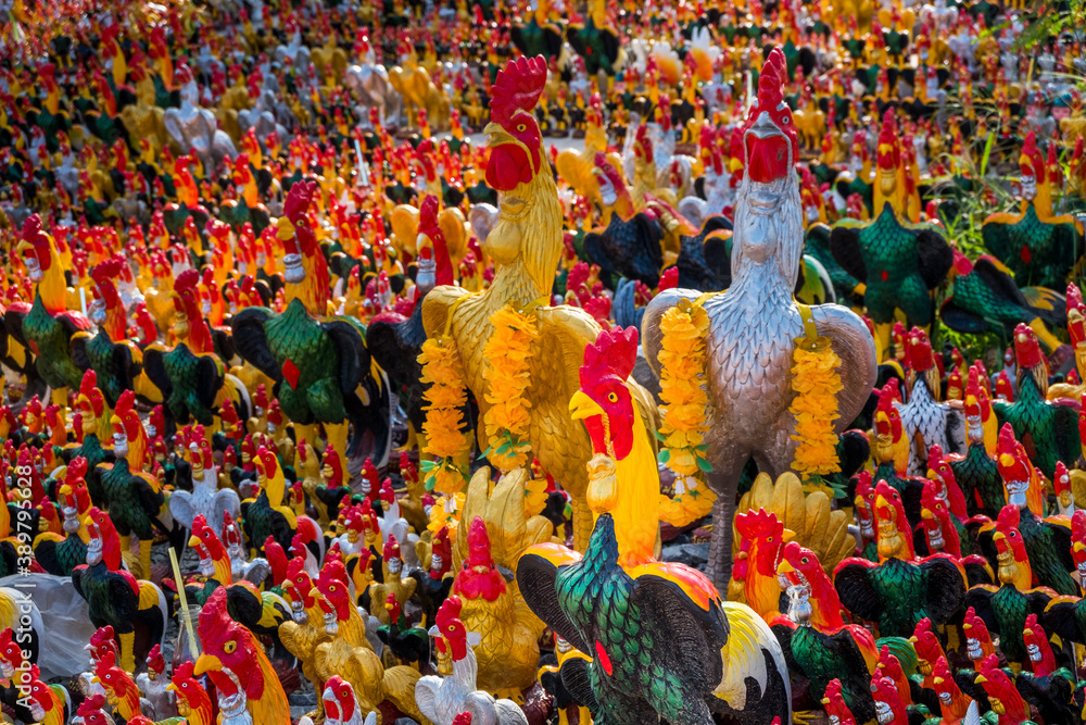 Chicken statues of various colors and sizes that people worship in the ...