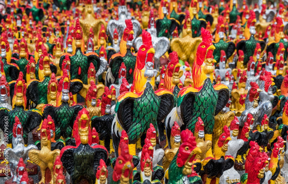 Chicken statues of various colors and sizes that people worship in the ...