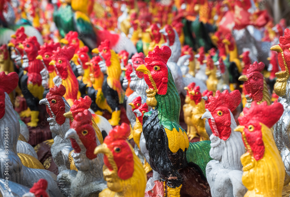 Chicken statues of various colors and sizes that people worship in the ...