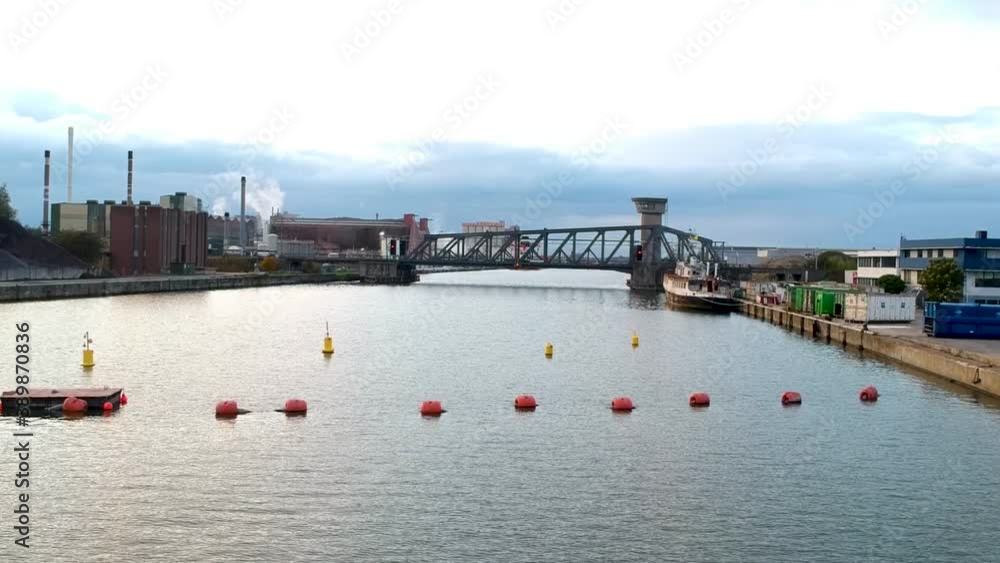 Drone rises over train bridge crossing the Schelde river in Antwerp ...