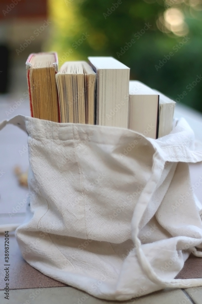 Canvas tote bag filled with books in the garden. Selective focus. Stock ...
