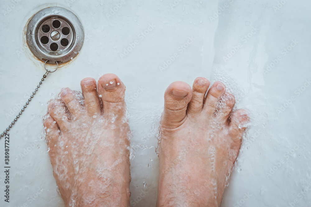 Wrinkled skin on the toes while showering in the bathroom Stock Photo ...