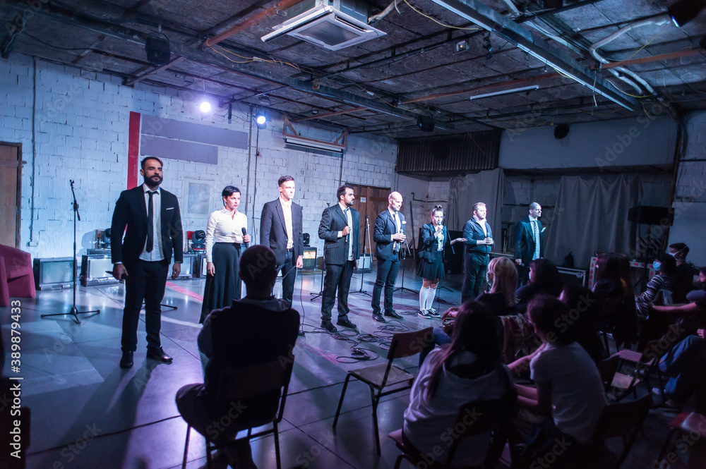 Large group of theater actor artists on stage perform play for audience ...