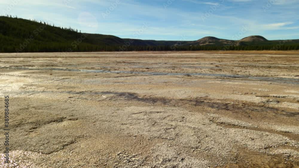 Yellowstone geyser mud flat sun flare walking 4K. Geyser Yellowstone in ...