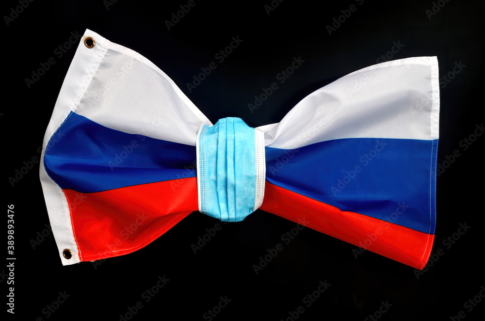 Flag of russia tied with a face protection mask. COVID - 19 problems in ...