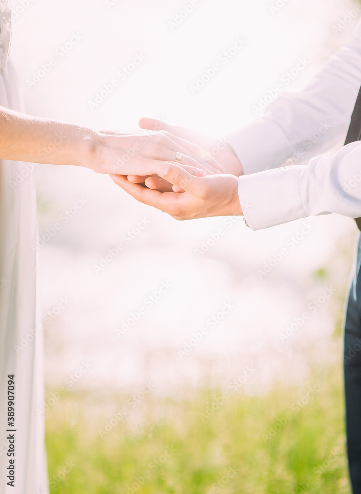 Wedding couple. Bride and groom hold hands. Engagement ring on white ...