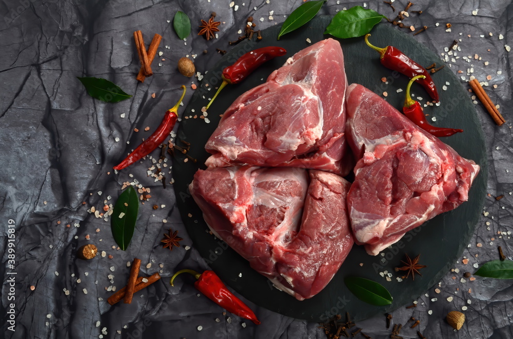 Fresh raw mutton shoulder meat isolated on black stone background with ...