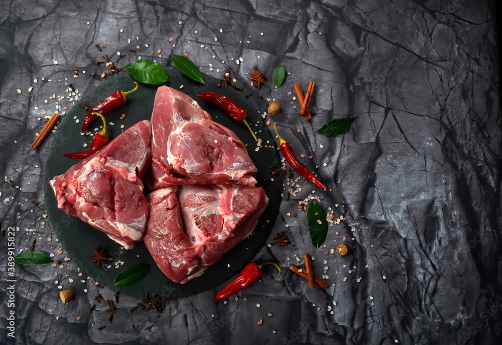 Fresh raw mutton shoulder meat isolated on black stone background with ...
