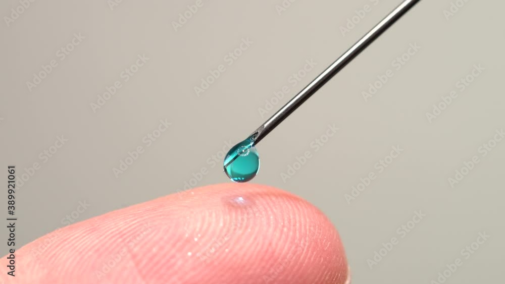 Finger touching medical syringe needle. Macro close up. Trypanophobia ...