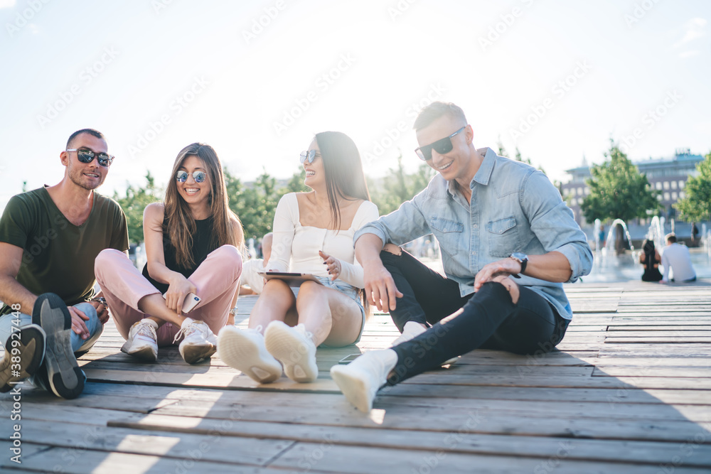 Positive friends chilling together in park Stock Photo | Adobe Stock