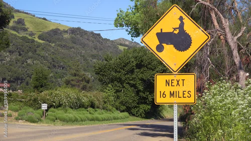 Road sign indicates there are farmers with tractors for the next 16 ...