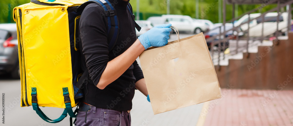 delivery boy of food delivery service walking down the street Stock ...