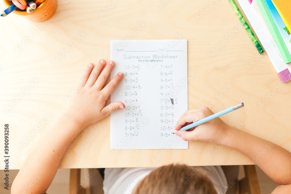 Top view of child hands with pencils. Solving maths exercises. 7 years ...