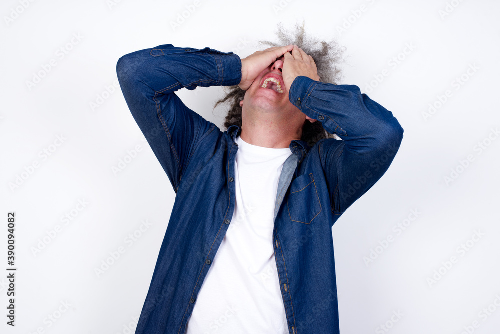 Shocked Handsome middle aged Caucasian man with afro gray hair, holding ...