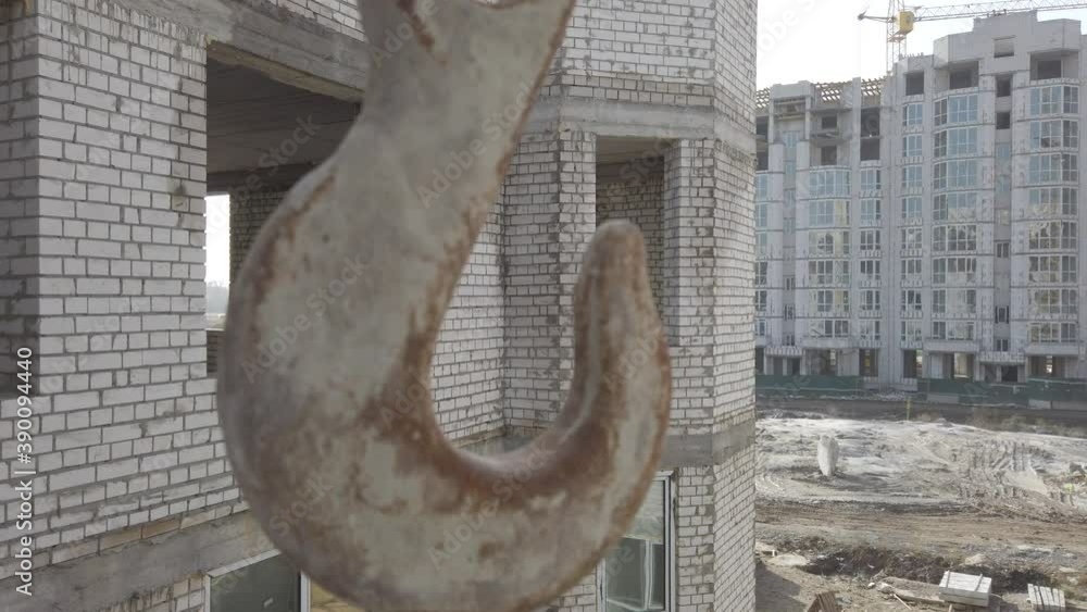 Large rusty hook used in construction to lift heavy equipment on a ...