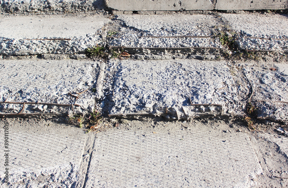 Old concrete stairs are crumbling from old age and poor repairs; good ...