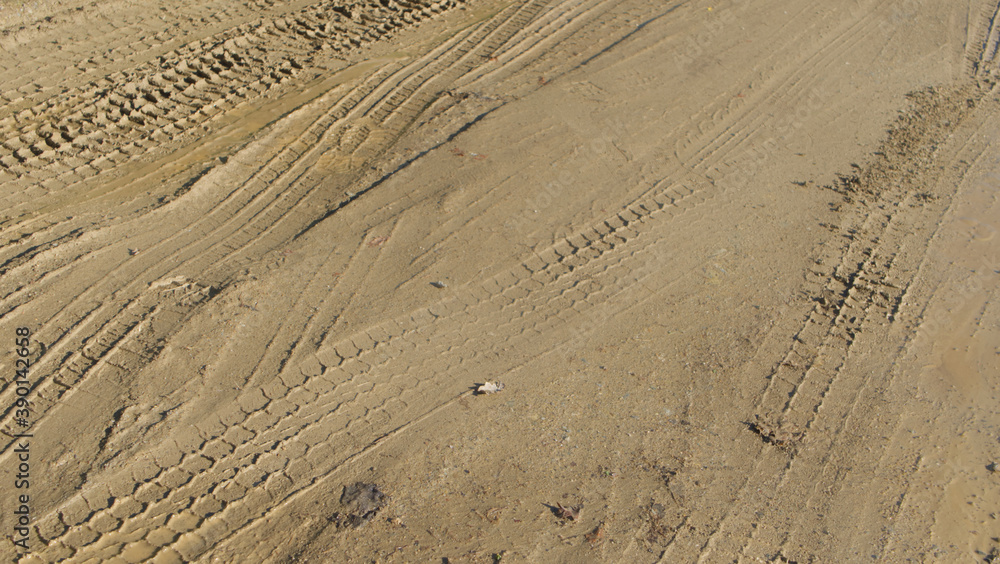 Muddy road with tyre tracks different tread patterns. Muddy wet track ...