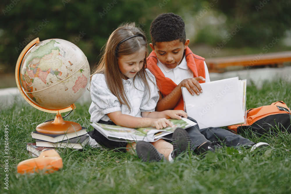 Mixed-races boy and little girl. Junior students in front of school ...
