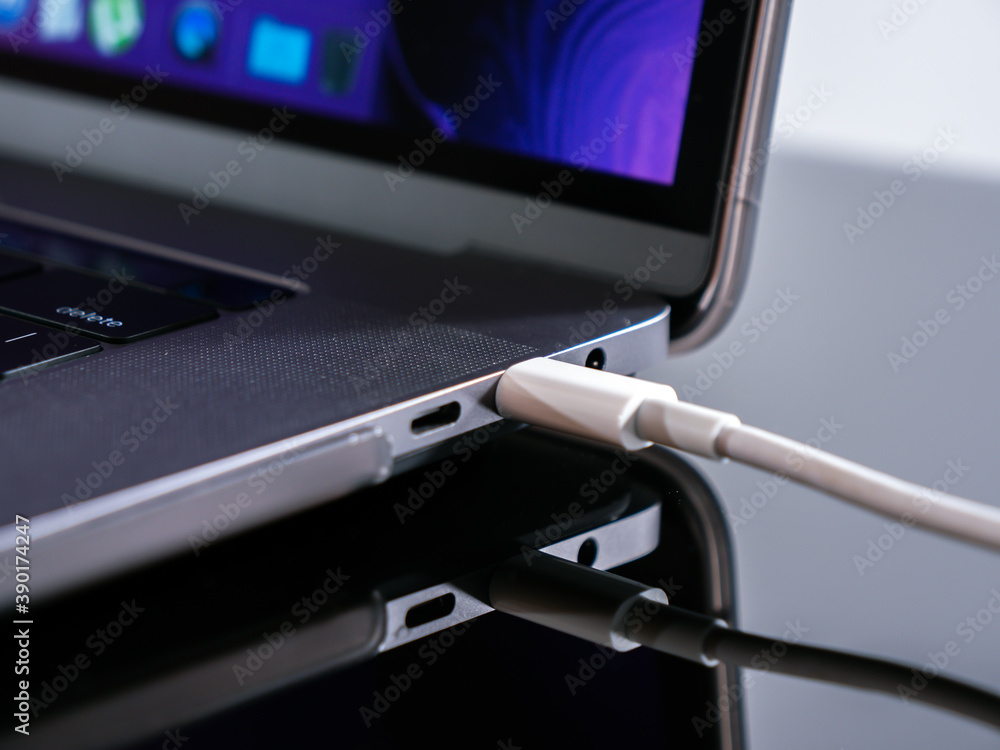 USB Type C cable being connected to the laptop computer. Fast charging ...