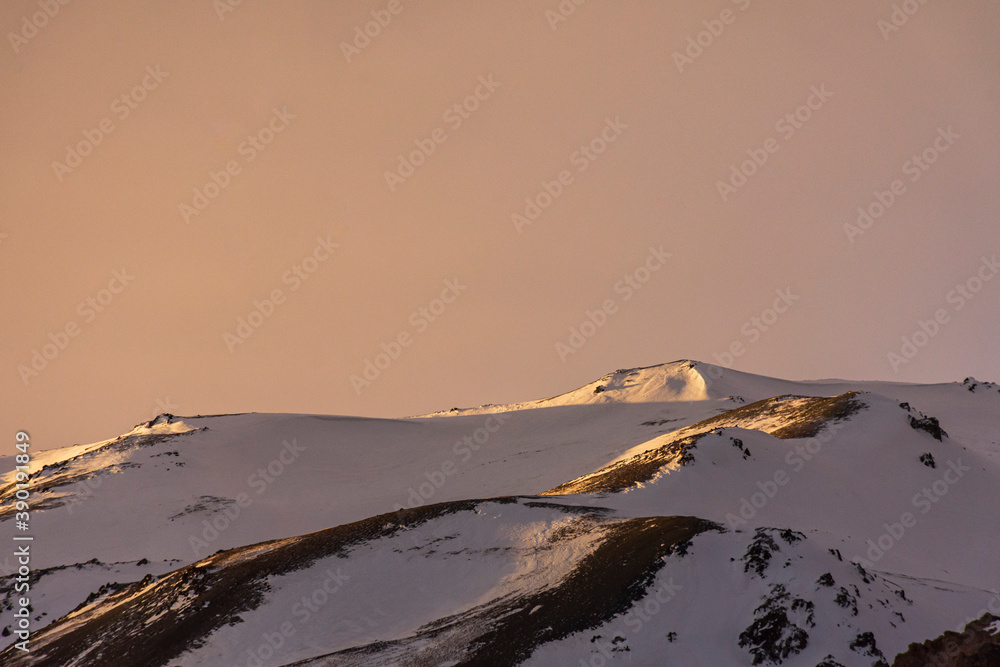 Alpenglow over snow-capped Andes mountains during sunset in Esquel ...