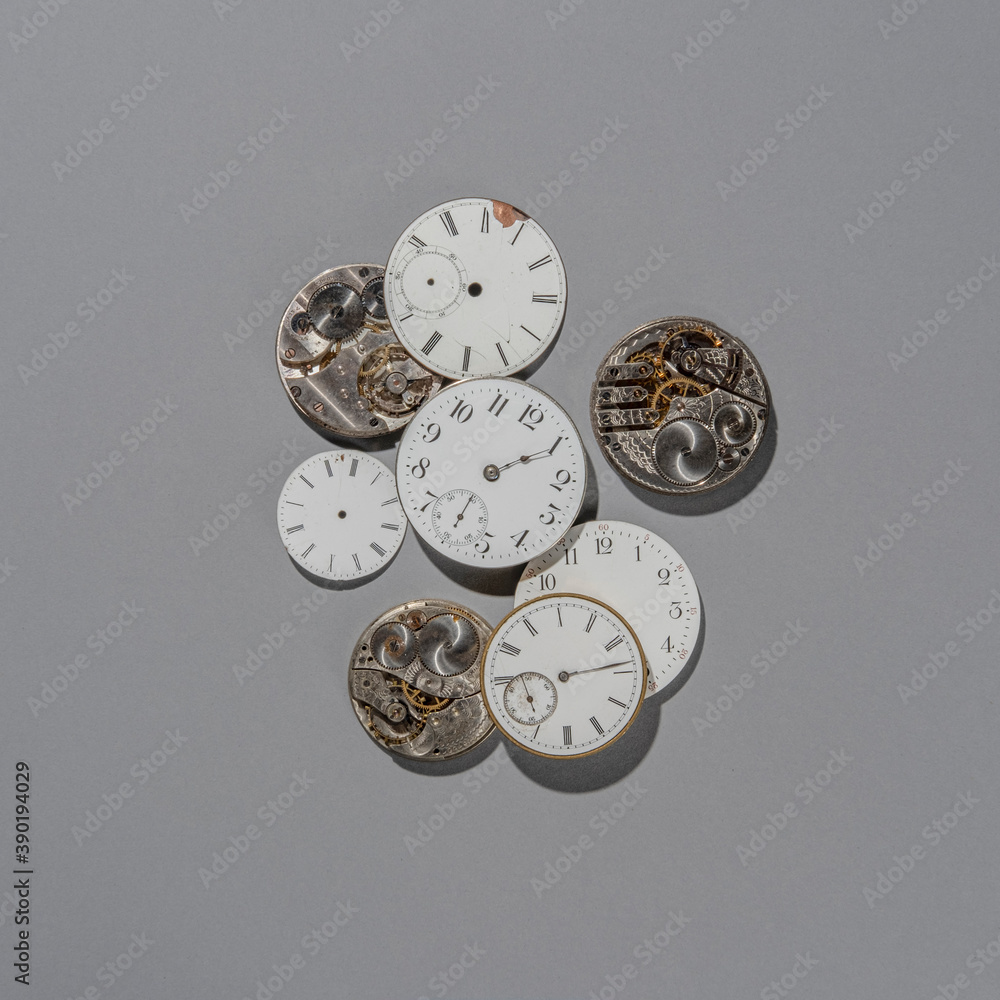 Retro watch faces and gears on grey background Stock Photo | Adobe Stock