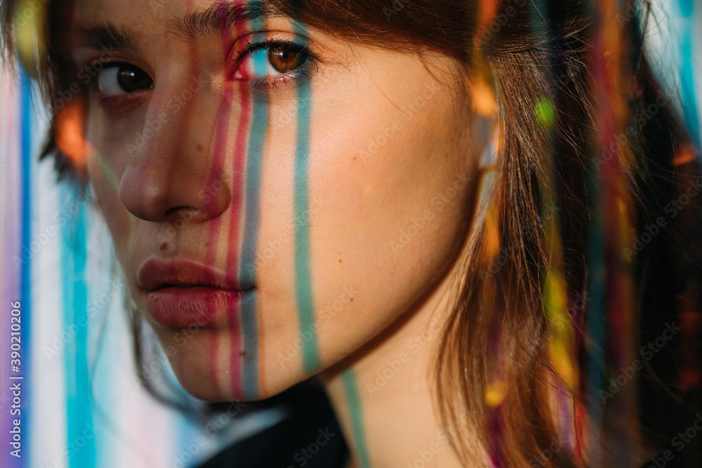 Colorful light lines on face of beautiful girl Stock Photo | Adobe Stock
