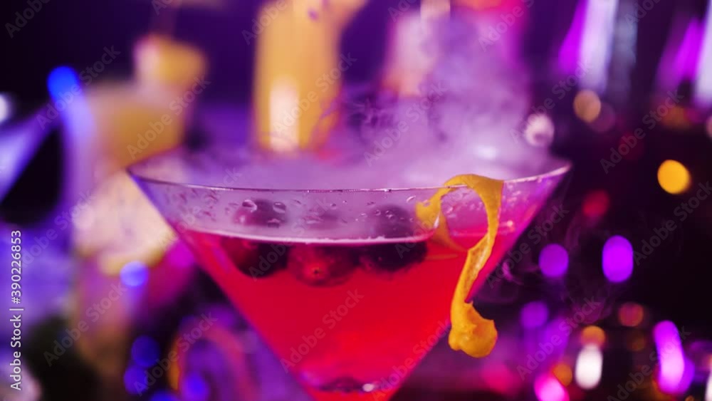 Cosmopolitan drink with cranberries at bar counter close up. Bartender ...