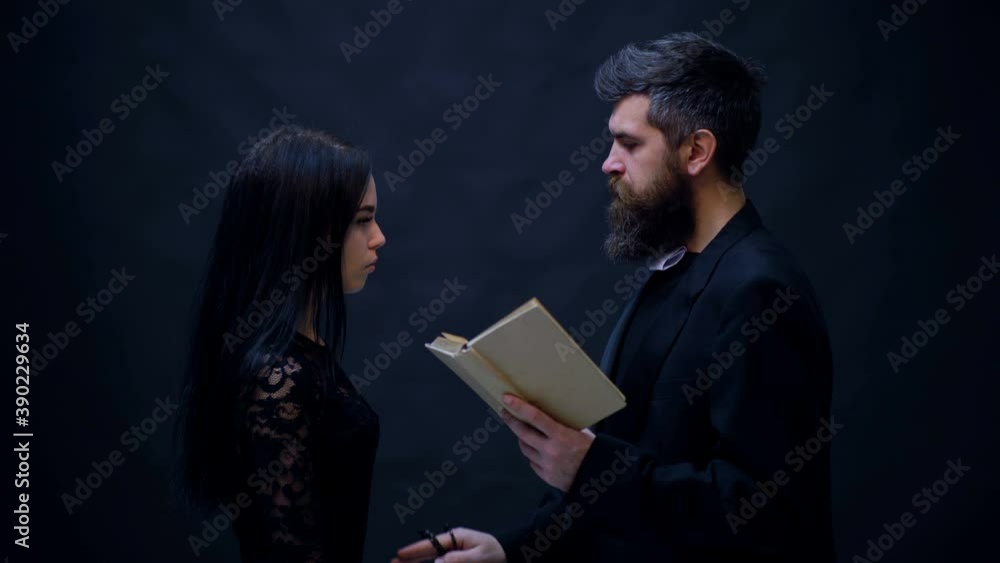 Young woman with pastor. Priest and prayer woman in the kneels. Girl is ...