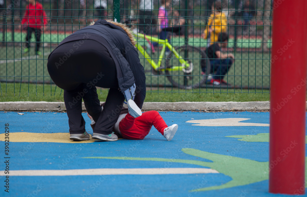 Baby is falling to ground and his mother is trying to save him. Mother ...