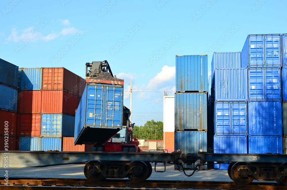 Shipping container loading by richtracker on the freight rail car at ...