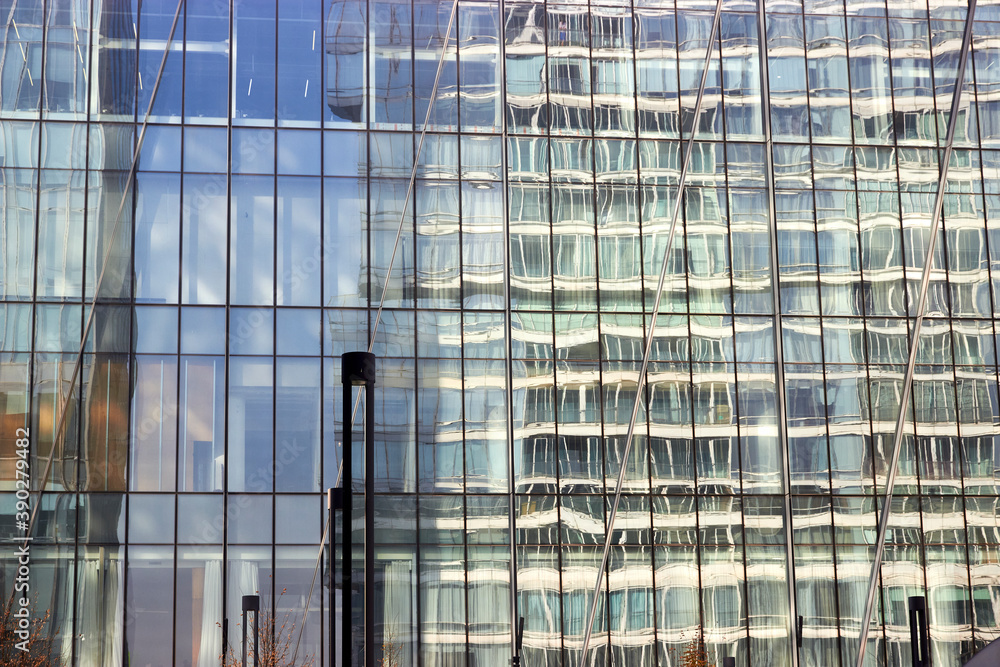 reflection of opposite standing building in windows of shopping center ...