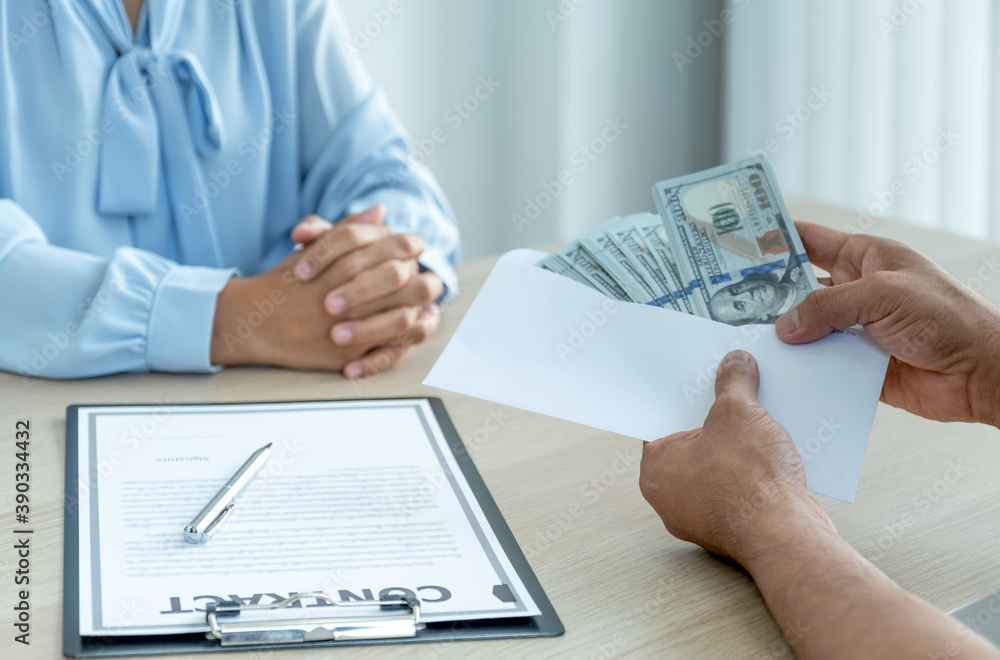 The hands of businessmen who bribe government officials to sign ...