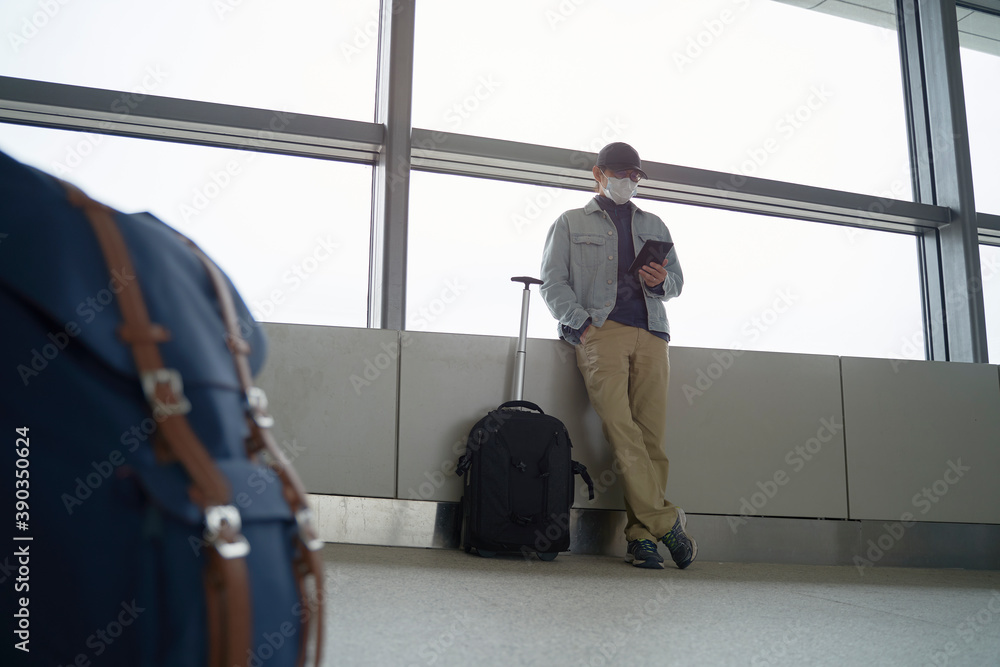 young asian man male air traveler reading e-book using a e-reader while ...