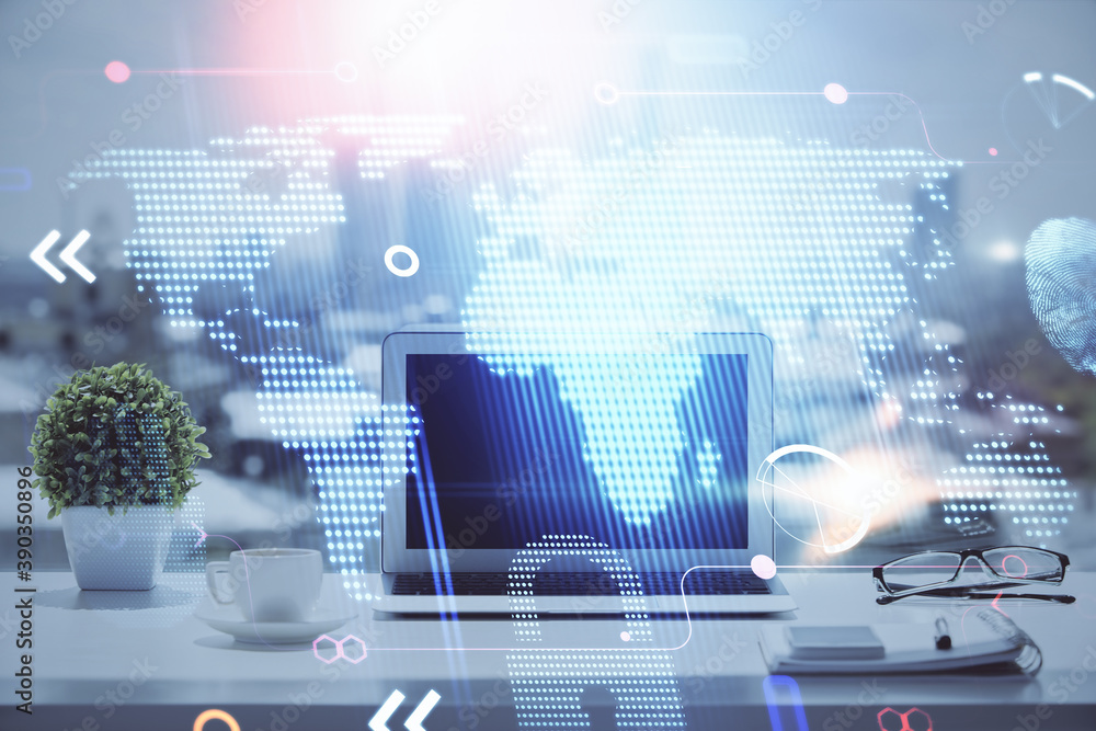 Double exposure of desktop with computer and world map hologram ...