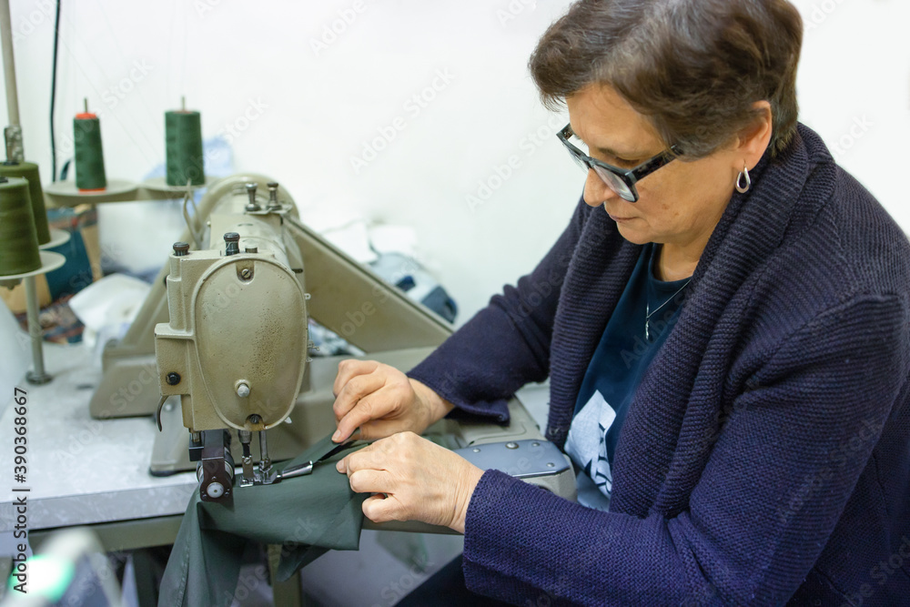 Tailor sews a clothes by machine.hand work concept related to ...