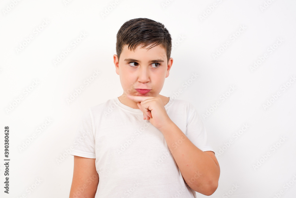 Dreamy Caucasian young boy standing against white background with ...