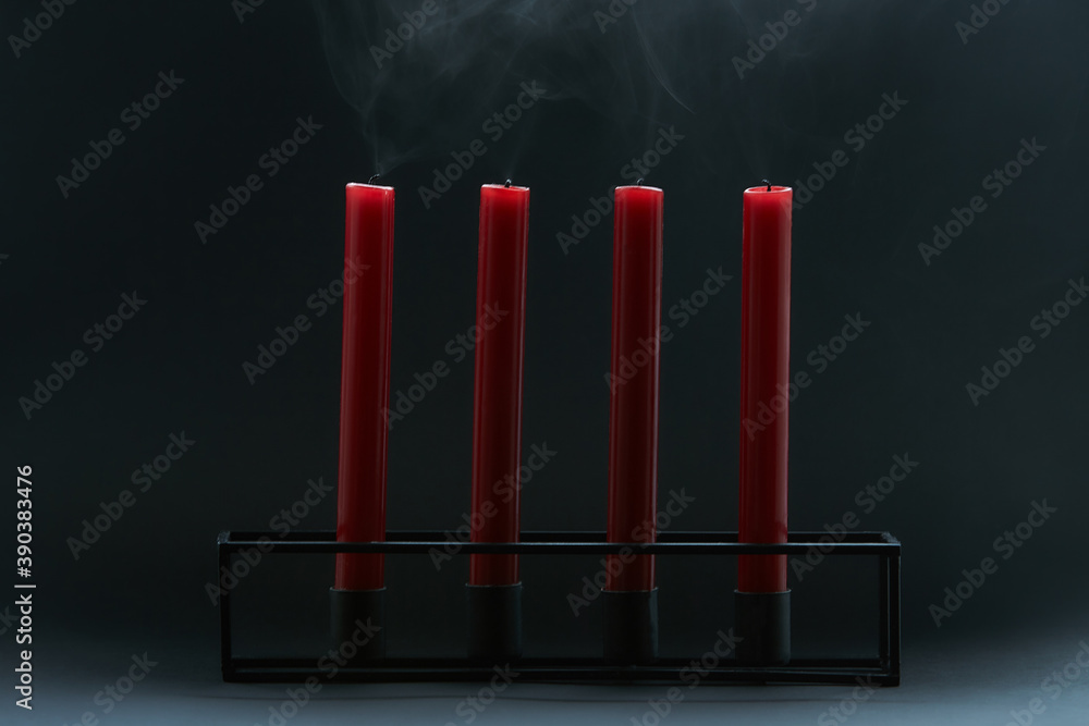 Candlestick with four red candles in the dark background. Christmas ...
