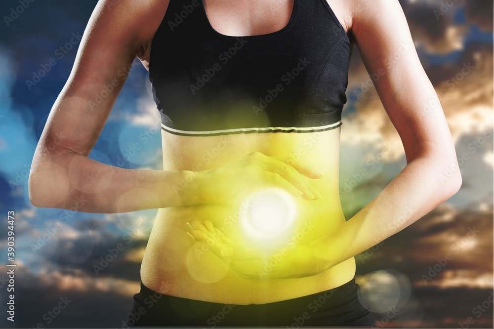 Beautiful woman's slim stomach, and hands showing a balance in her ...