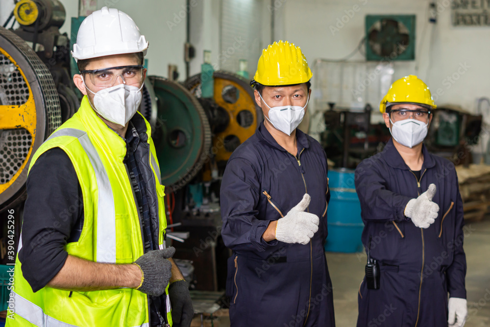 Leader engineer and partnership wearing protective uniform and hardhats ...