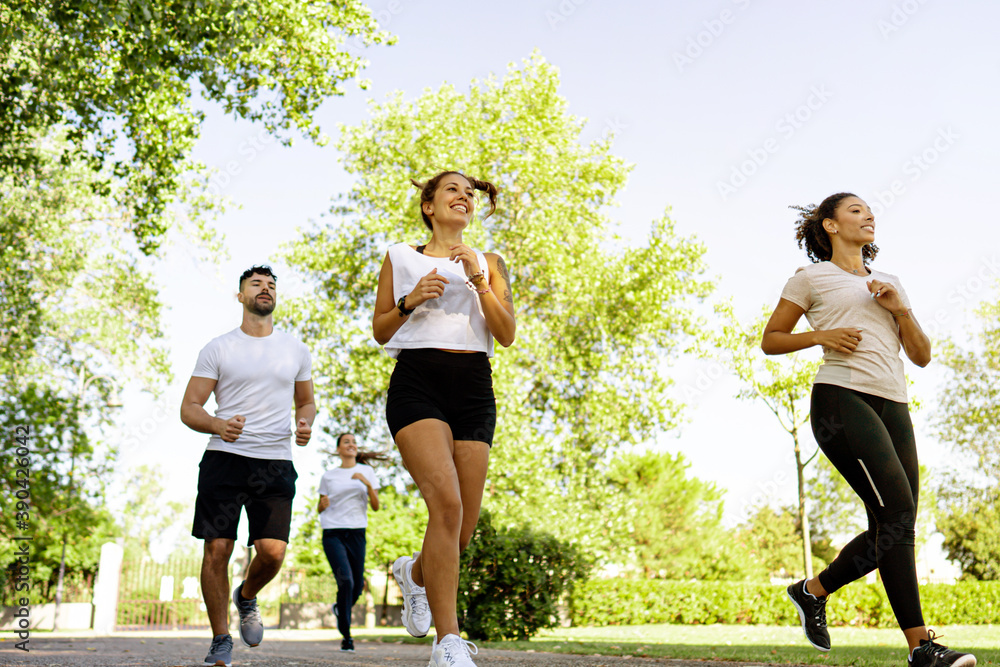 Group of young multiracial happy people doing jogging in the morning at ...