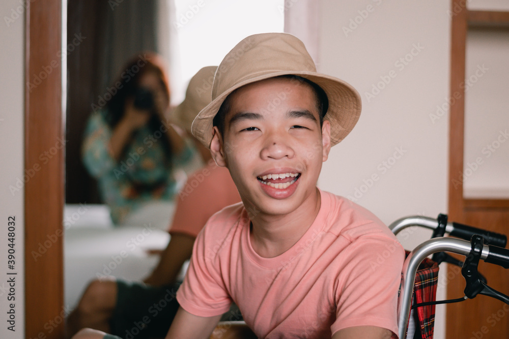 Disabled child on wheelchair is smiling and his mother in the mirror ...