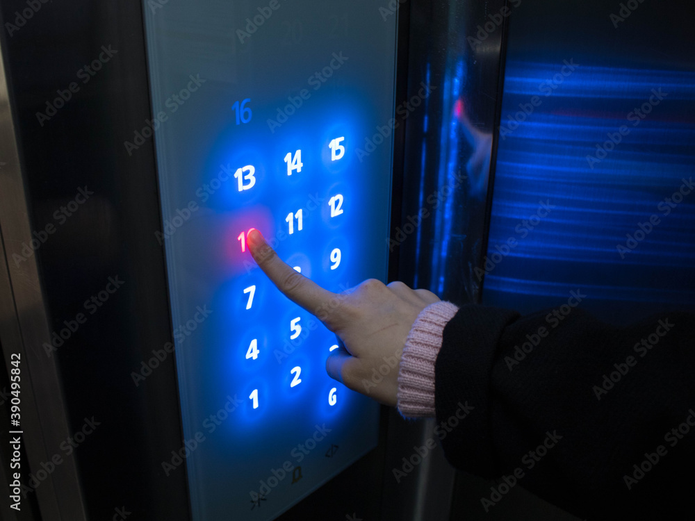 Hand pushing a button on an elevator, calling a lift, buttons of a lift ...