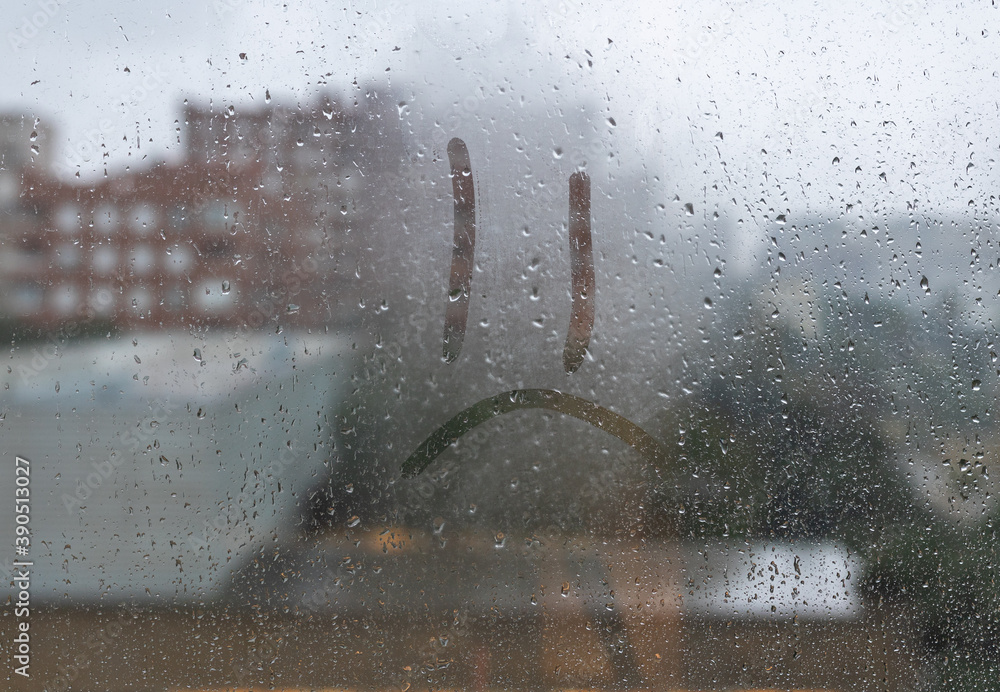 Sad face drawing on the window on a rainy day in Spain . Depression and ...