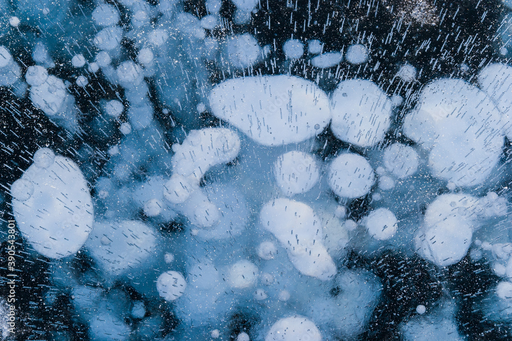 Beautiful transparent blue ice with frozen white methane bubbles ...