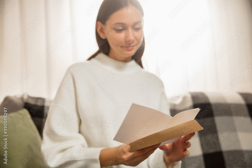 Woman opening, recieving greeting card for New Year and Christmas 2021 ...